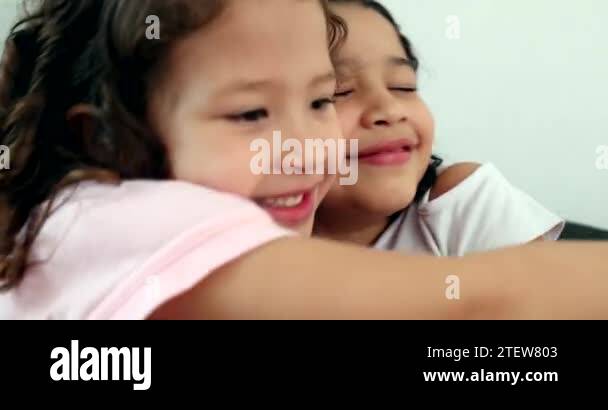 Children hugging each other, two little sisters hug in affection and ...