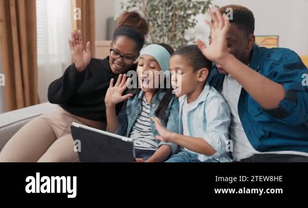 The family is spending time together on the couch the parents and their ...