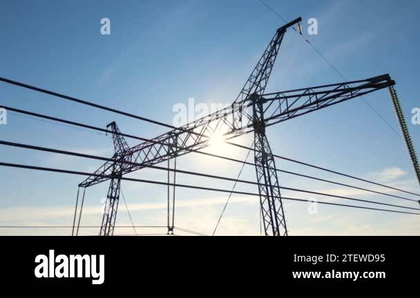 High voltage tower with electric power lines divided by safe guard ...