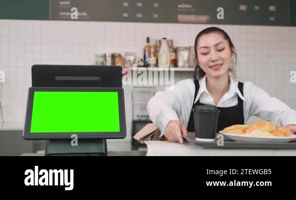 Touch screen cashier machine with blank green screen at modern coffee ...