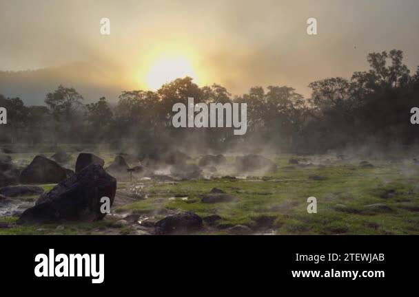 Fang Hot Springs and rocky terrain with the misty morning and natural ...