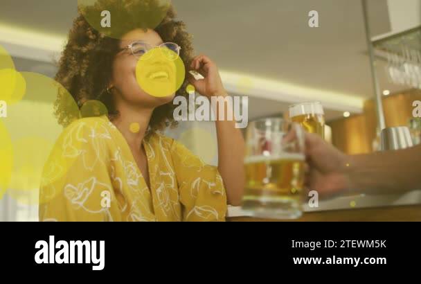 Animation of spots over happy biracial woman with caucasian friend ...