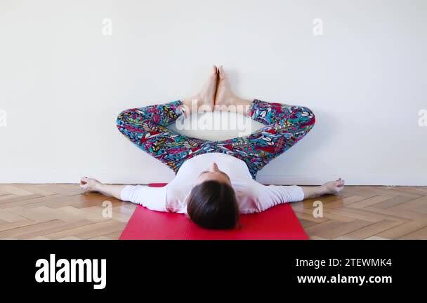 Yogui caucasian woman in a butterfly, shoeman, Baddha Konasana inverted ...