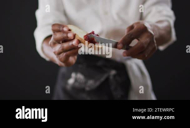 Video of cook grease bread with butter on black background. food and ...