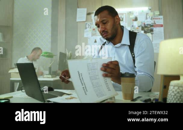 Serious detective opening folder with criminal records, homicide case ...