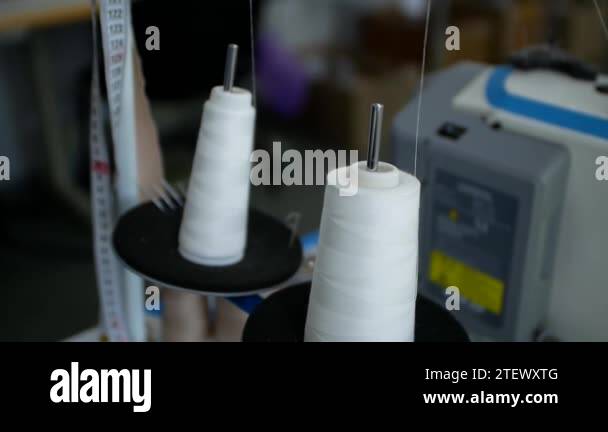 spools of thread for the sewing machine. A sewing machine removes ...