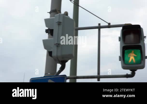 The cross traffic light is on green for pedestrians walk at the city ...