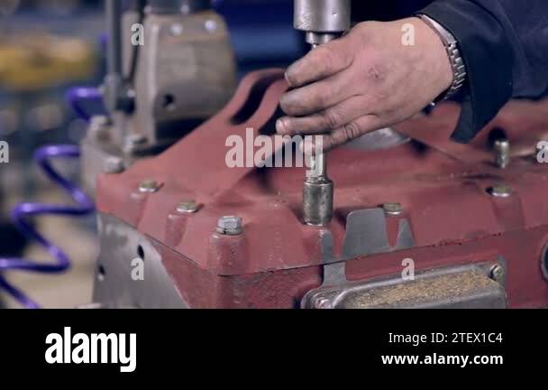 Worker tight nuts on motor, engine by automatic screwdriver Stock Video ...