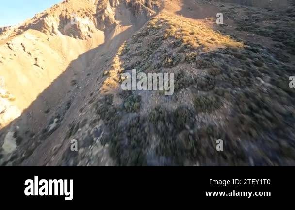Cliff rock and mountain surfing with a FPV drone in a desert and moon like sandy and rocky ...
