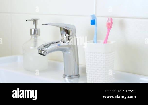 Woman changing old brushes for new modern ultrasonic toothbrush in ...