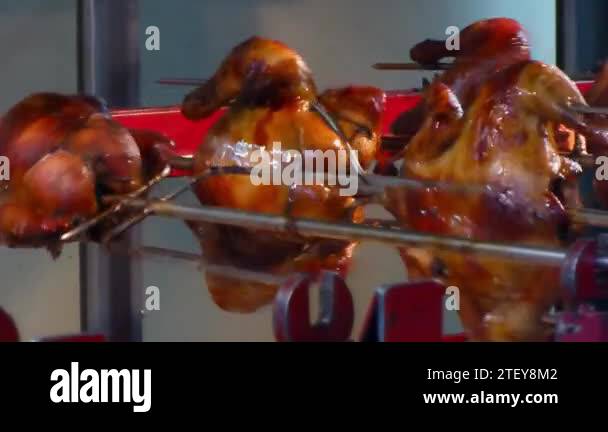 A typical Philippine rotisserie being used for roasting marinated ...