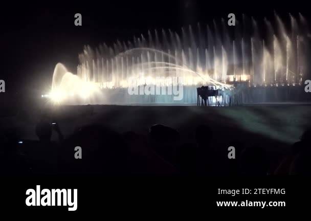 Singapore musical fountain show with white lights and lens flare, water ...