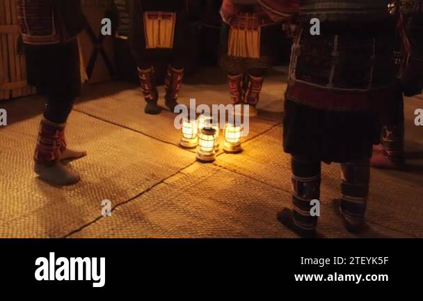 Indigenous performing arts to tourists. At night dimly light, Akha hill ...