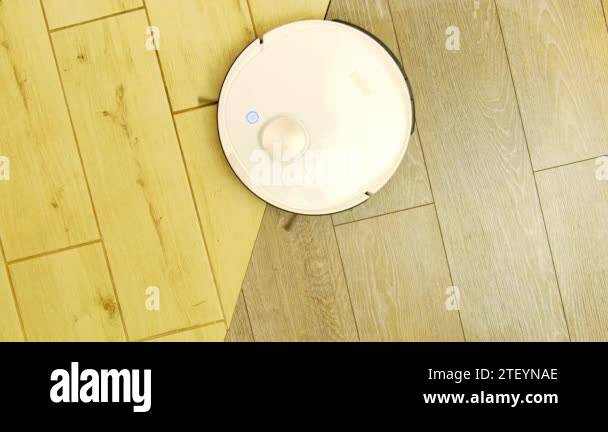 Robot vacuum cleaner uses sensors to ride on different part of floor in ...