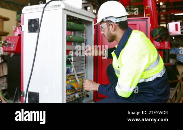 Electrical technicians operating the control system, control cabinets ...