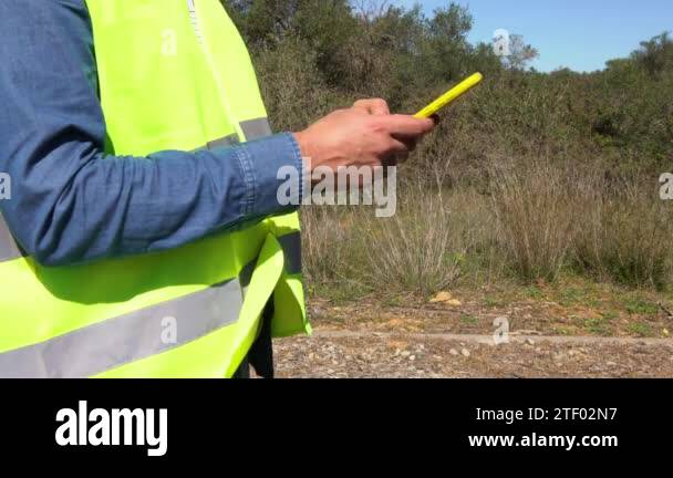 Male hands using smartphone to texting for assistance, standing near ...