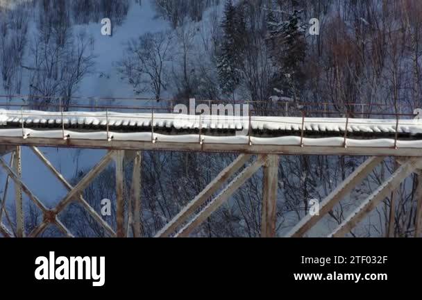 An old Japanese railway bridge is located in the mountains between the ...