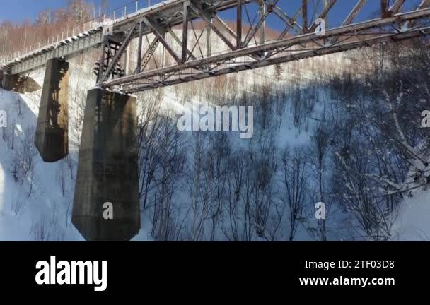 An old Japanese railway bridge is located in the mountains between the ...