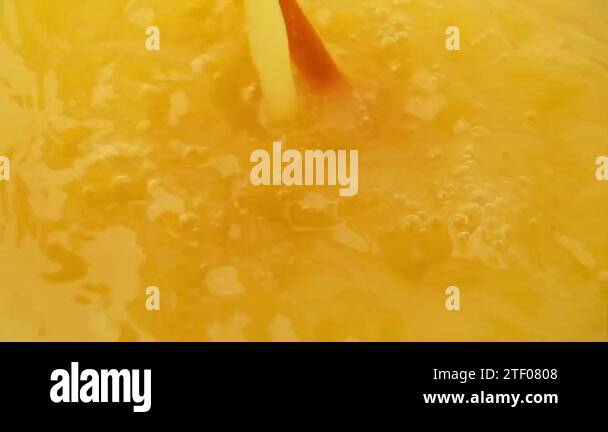 Pouring and splashing orange juice. Orange slices falling into juice ...