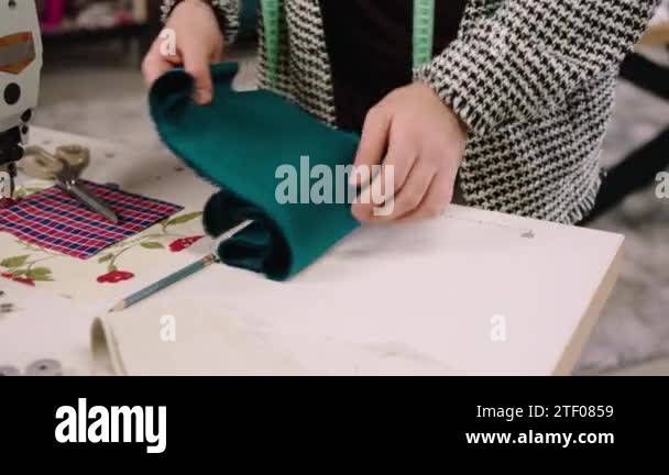 Closeup taking video details of a man using the fabrics to start sew ...