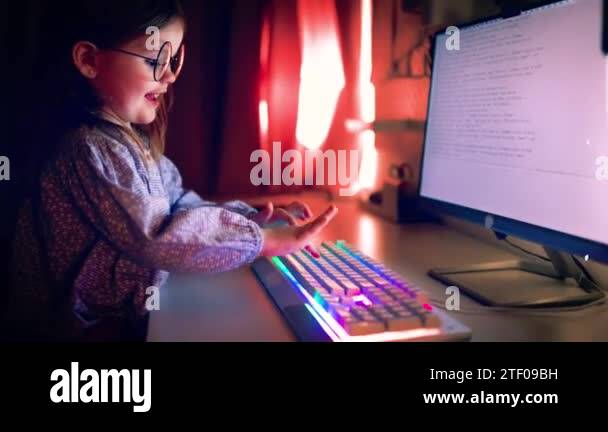 cute baby girl having fun, typing on keybord, reading text at the ...