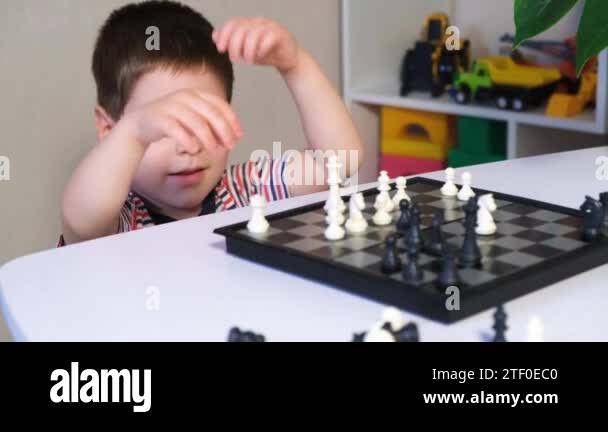 A boy of 4 years old learns to play chess, makes the wrong castling of the tour and the king ...