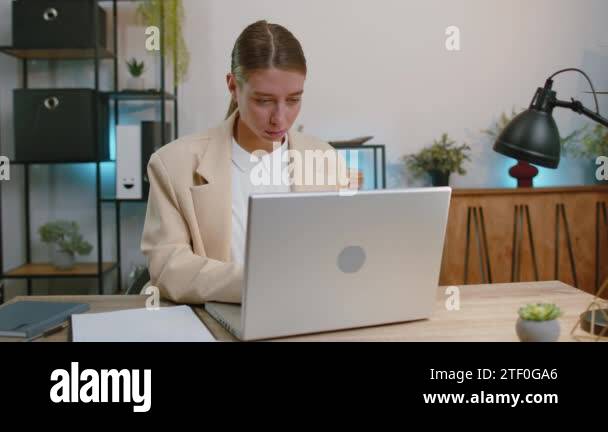 Businesswoman working on laptop computer shakes finger and saying no ...