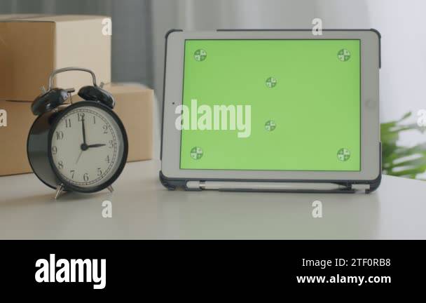 Tablet with blank green screen chroma key template on the table and ...