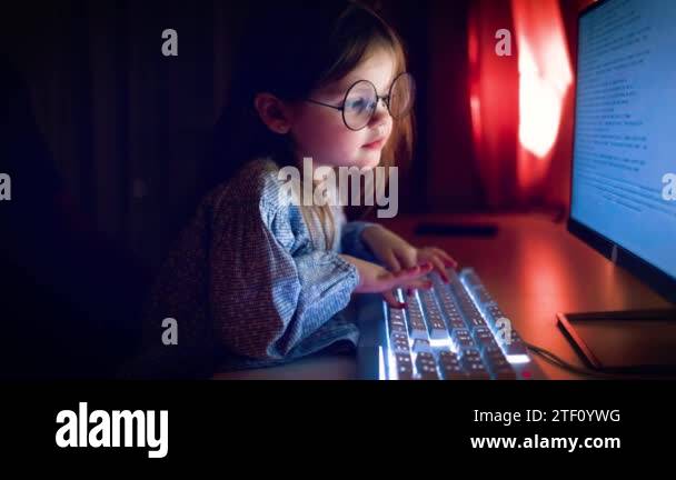 cute baby girl having fun, typing on keybord, reading text at the ...