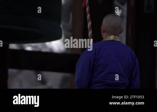Tokyo, Japan-03 February, 2020: The Buddhist priest monk hits ringing ...