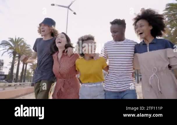 Friends run around hugging, having fun together during vacation. Group ...