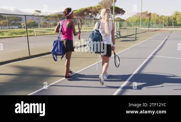 Video of back of diverse female tennis players holding racket, walking ...