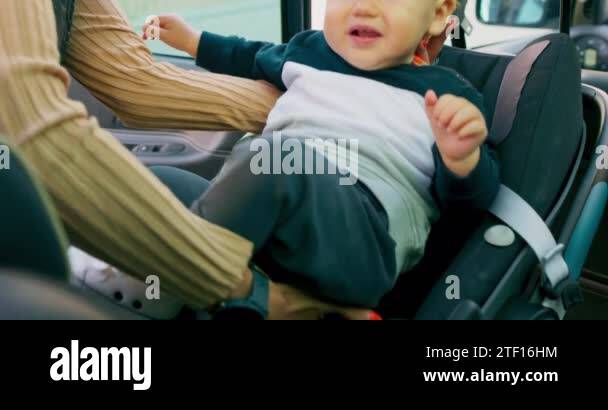 Camera inside the car. Closeup baby car seat. Baby boy appears, carried ...