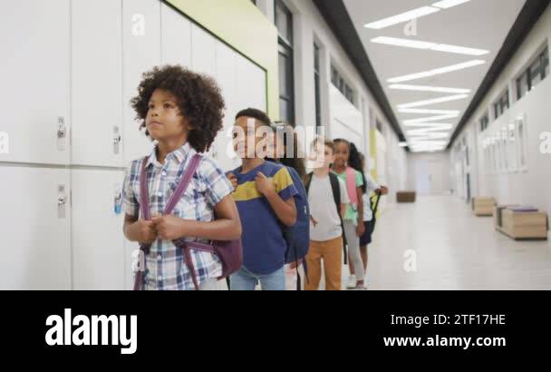 Video of happy diverse pupils standing in row and smiling before ...