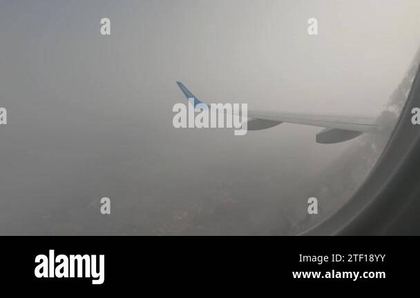 Passenger view through the airplane window. Clouds through the window ...
