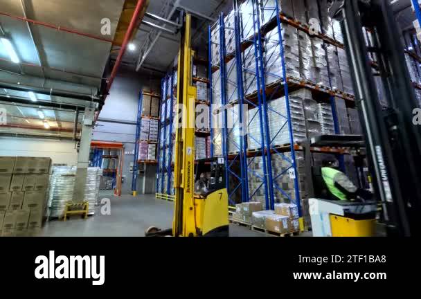 Forklift work in a warehouse. Modern forklift works in a warehouse ...