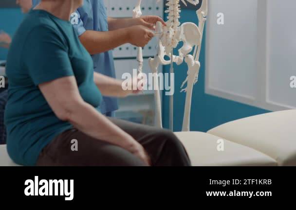 Male doctor pointing at human skeleton to show spinal cord Stock Video ...