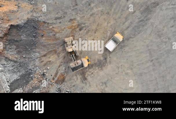 Open pit mining of loading the stone gravel into heavy dump truck at ...