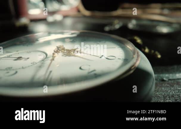 Silver antique pocket watch with ticking gold hands and vintage camera ...