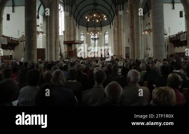 Overview shot - Audience in a church listening to a concert - Wide shot ...