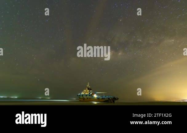 Timelapse footage of Stranded boat on the shore during low tide with ...