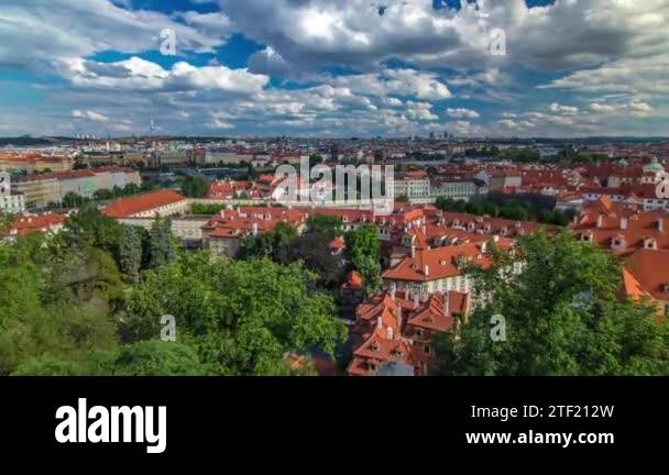 Panorama of Prague Old Town with red roofs and green trees timelapse ...