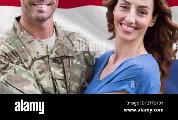 Animation of caucasian male soldier with wife over flag of netherlands. armed forces day ...