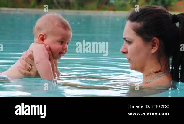 Mother and baby interaction at the swimming pool eskimo kiss Stock ...