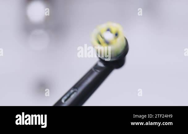 Rotating worn out bristles of electric toothbrush. View of old ...