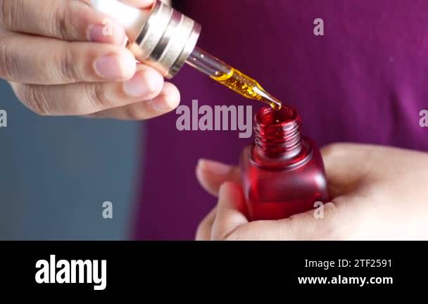 women hand Drop falls from a pipette into a cosmetic bottle Stock Video ...