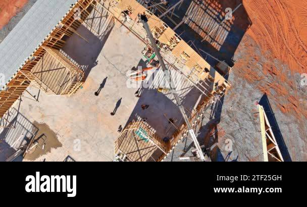 The construction with crane holds detailed of a wooden roof truss ...