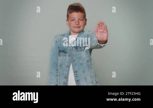 No stop. Serious boy say no, hold palm folded crossed hands in stop ...