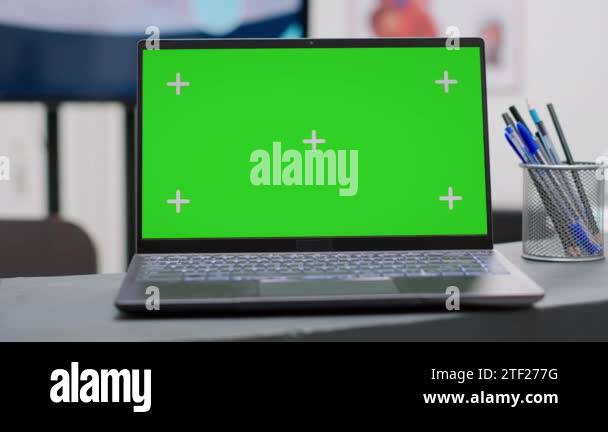 Laptop with greenscreen display on facility reception counter in ...