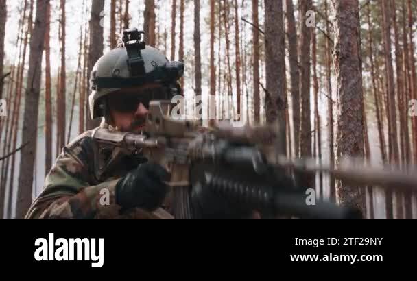 A soldier in a special military uniform with a helmet on his head and ...